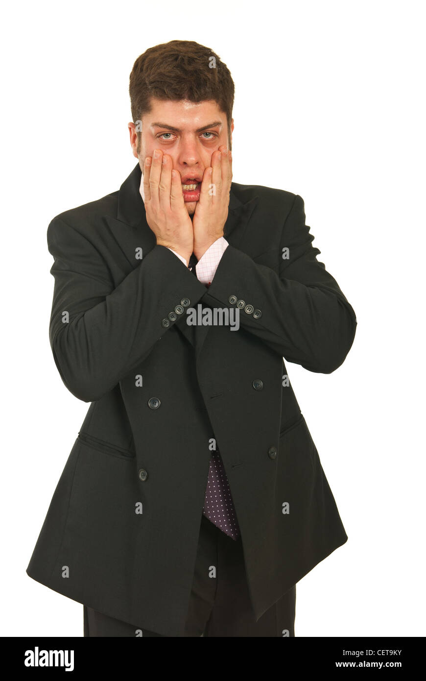 Extremely desperate business man holding hands to face and being very ...