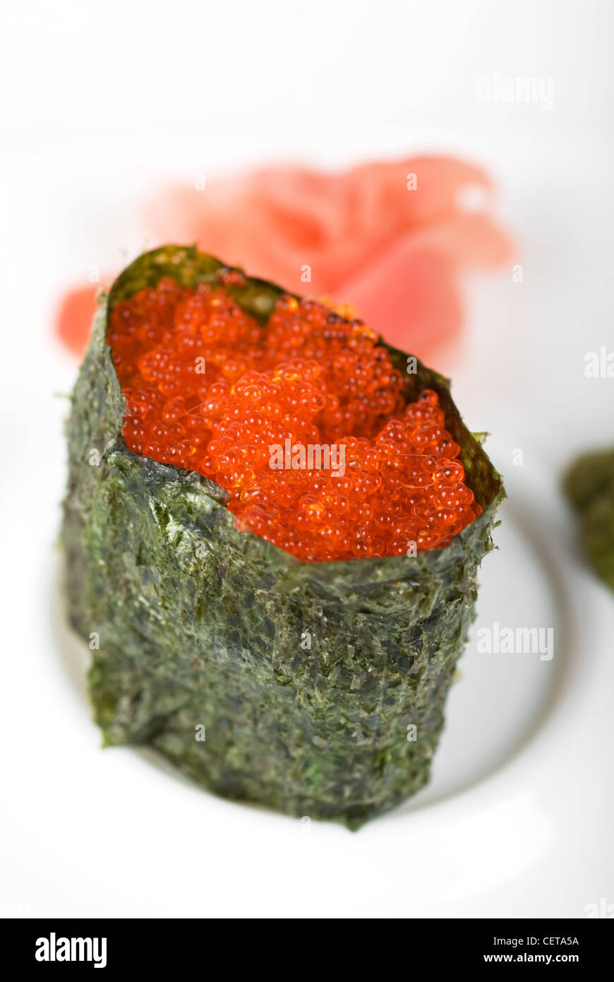 Red tobiko (flying fish roe) sushi closeup Stock Photo - Alamy