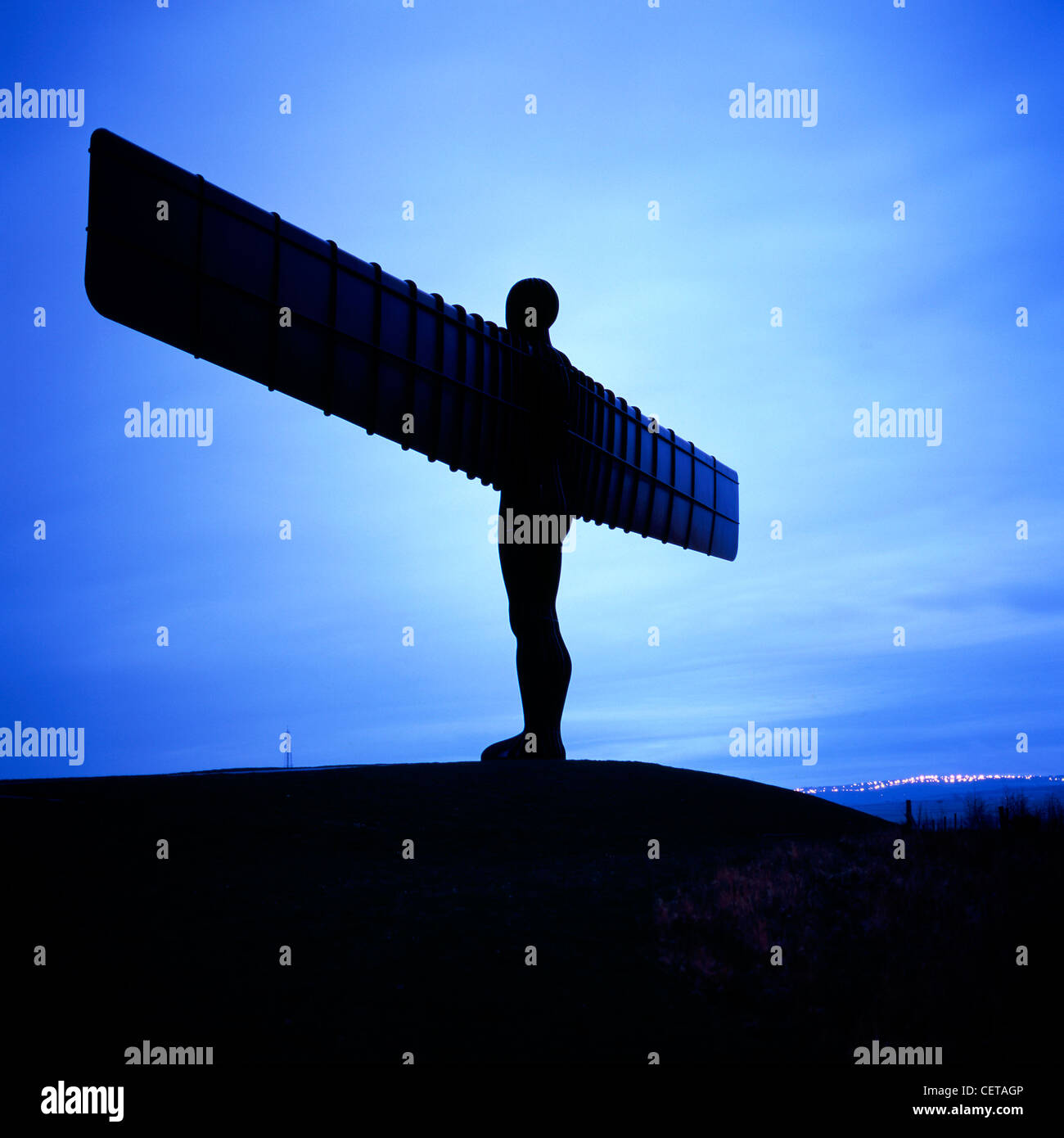 Angel of the North at dusk. The statue's wings measure 54 metres making ...