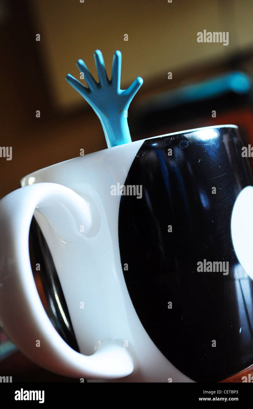 hand shape spoon in a mug Stock Photo - Alamy