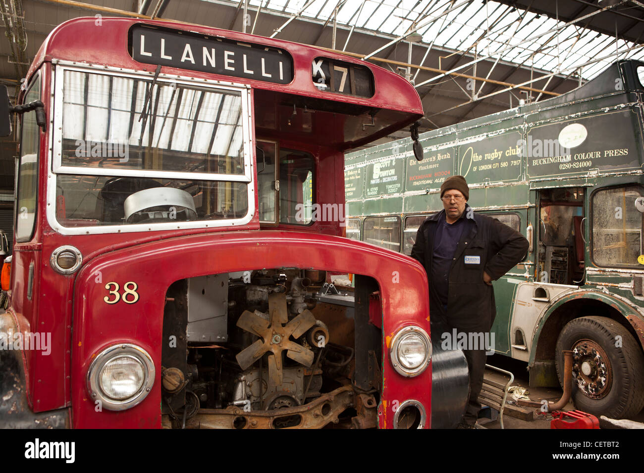 UK, Wales, Swansea, Docks, Bus Museum, volunteer restoring engine of ...