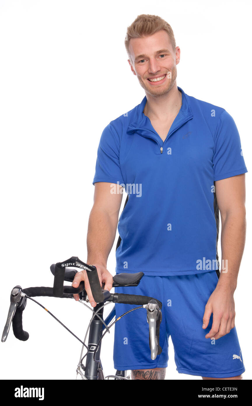 Young man with bike in front of white background Stock Photo - Alamy