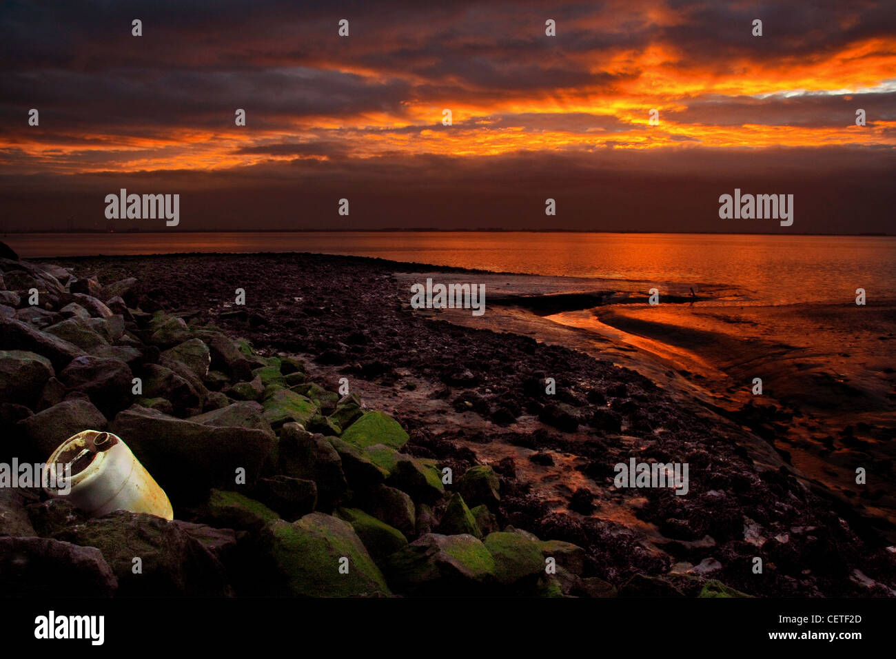 A discarded plastic barrel laying on the rocks on the Humber Estuary at ...