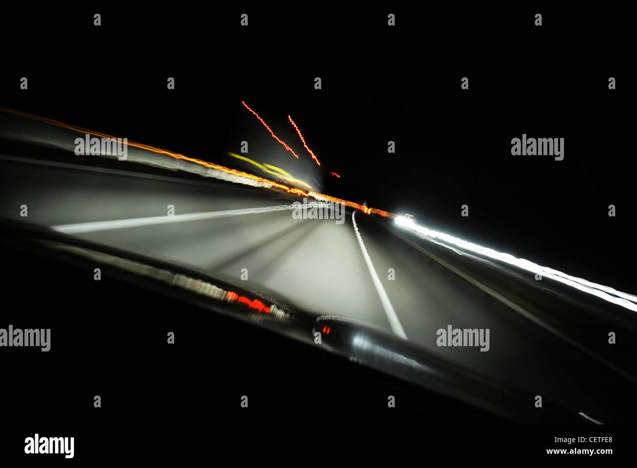A view from a moving car to light trails on the M1 motorway at night ...