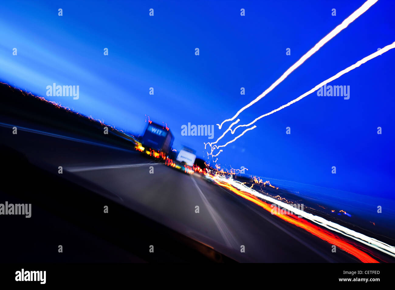 A view from a moving car to light trails on the M1 motorway at night ...