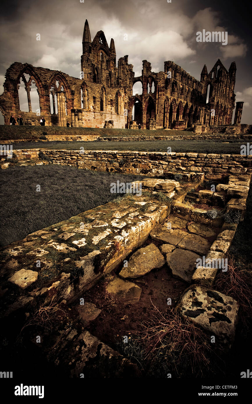 Dark clouds over the ruins of the Benedictine abbey at Whitby Stock ...