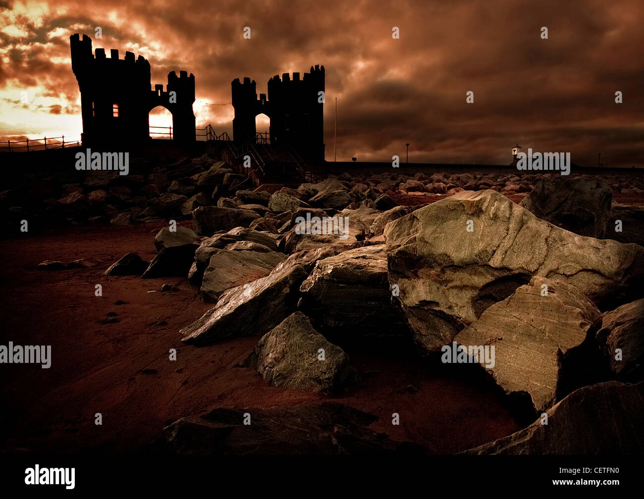 A dusk view from beside the rocks on the beach to the Old Pier Towers ...