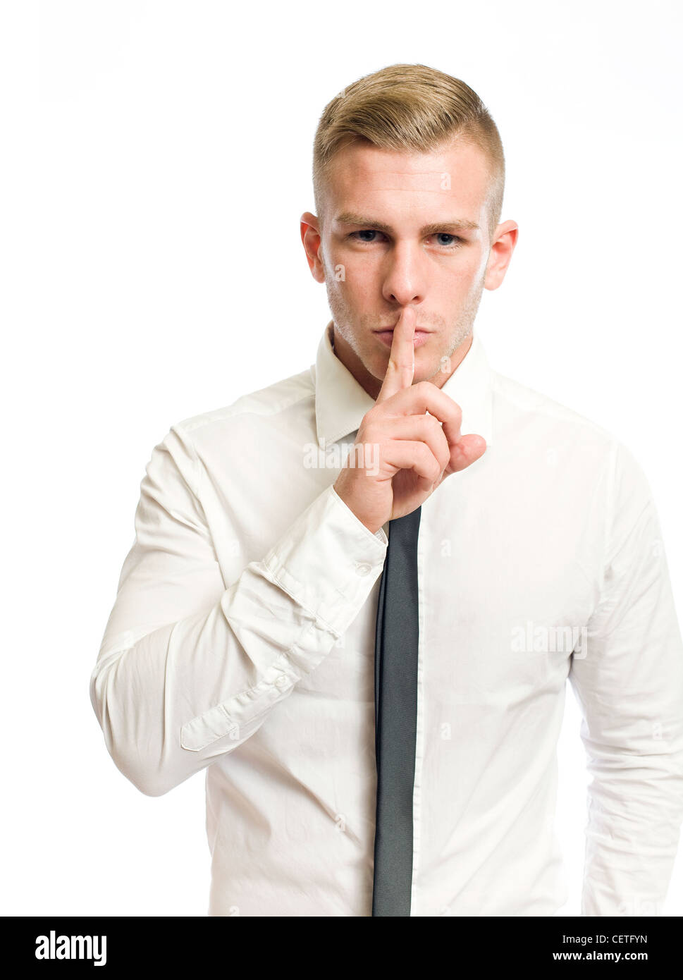 Elegant young businessman showing silence gesture, hand over mouth ...
