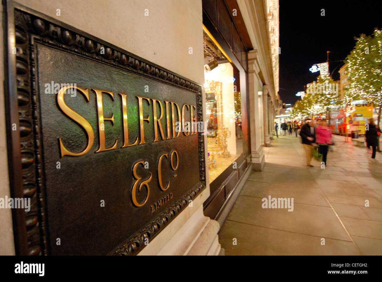 Detail of Selfridges sign at night. The development of Oxford Street as ...