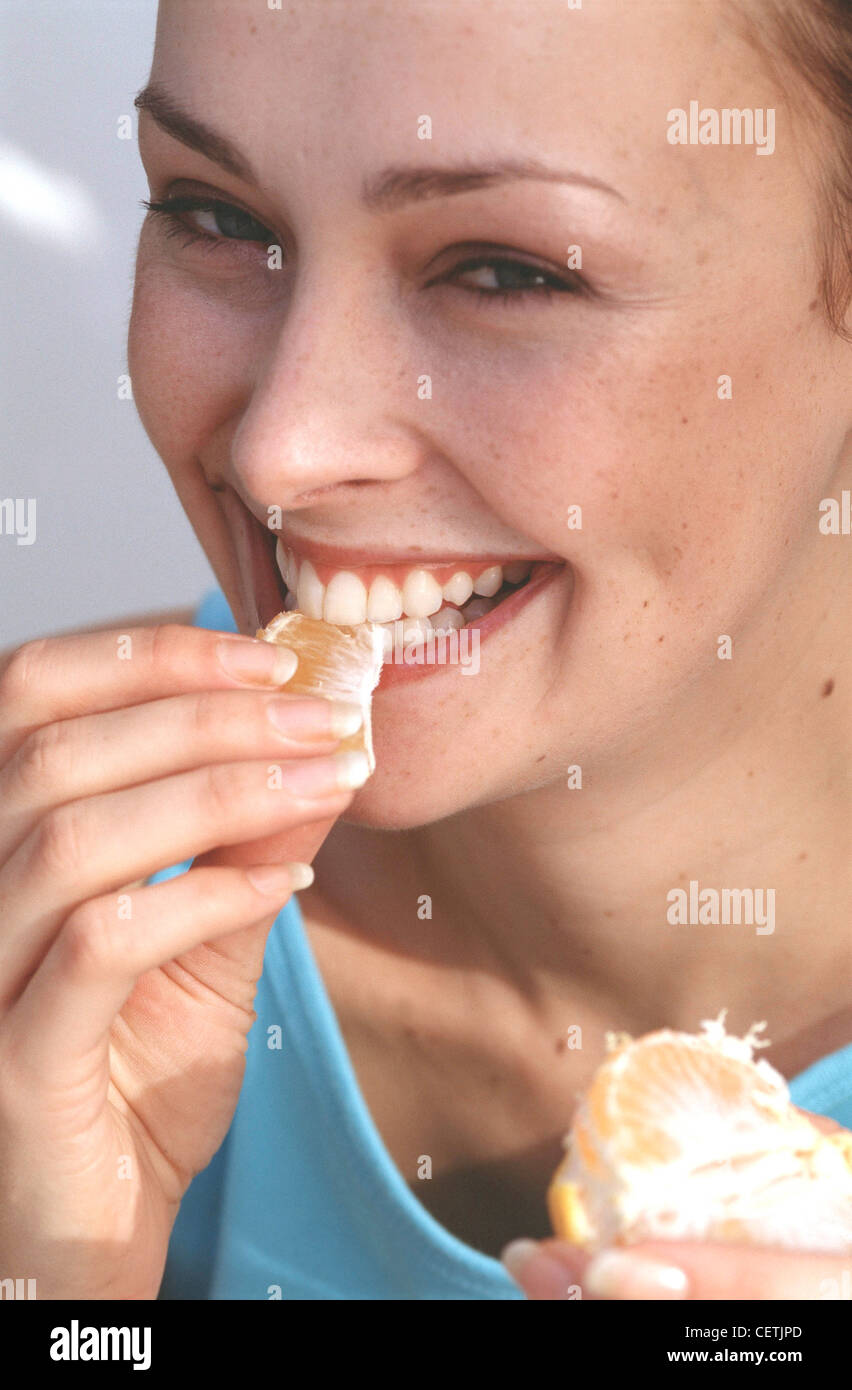 Cropped female hair off face wearing subtle make up blue vest top ...