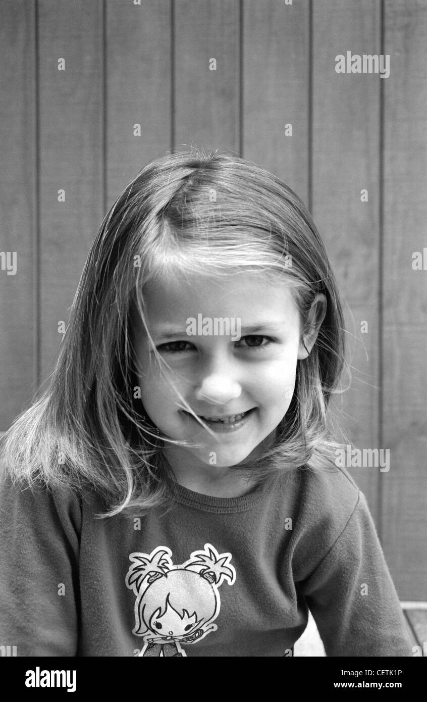 Smiling child girl showing Black and White Stock Photos & Images - Alamy