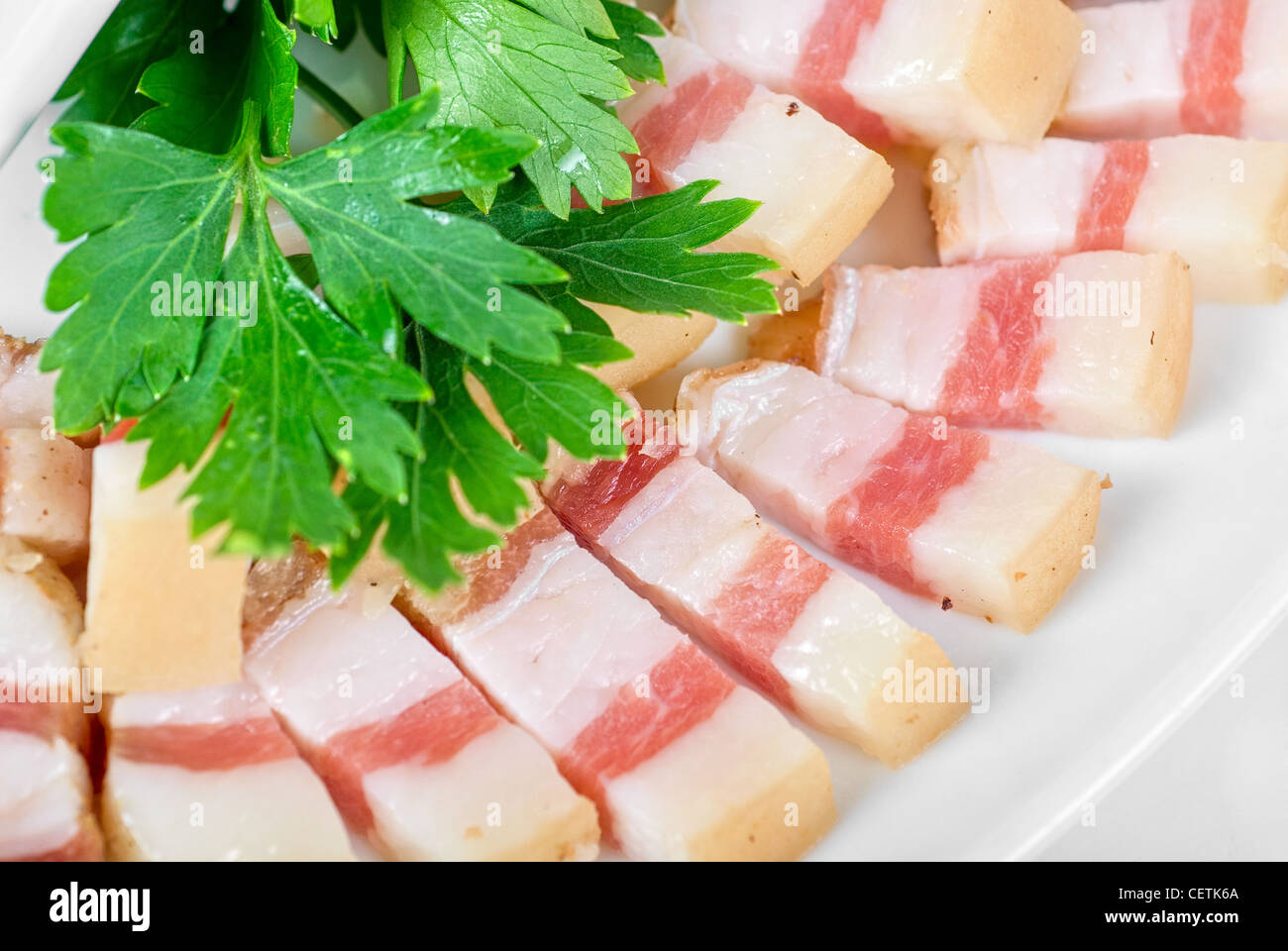 Sliced pig lard with greens closeup Stock Photo - Alamy