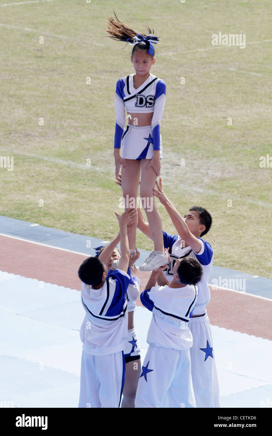 High school girls and boys play cheerlead in athletic field Stock Photo ...