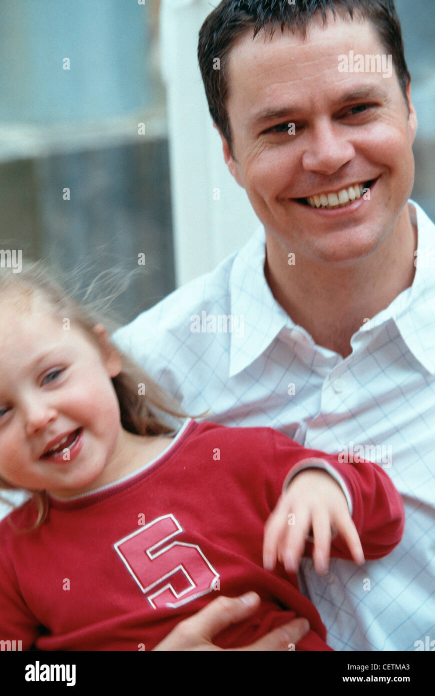 Father with short brown hair female child blonde hair sitting on lap ...