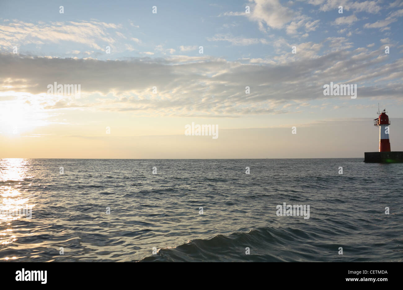 Sea sunset lighthouse Stock Photo - Alamy