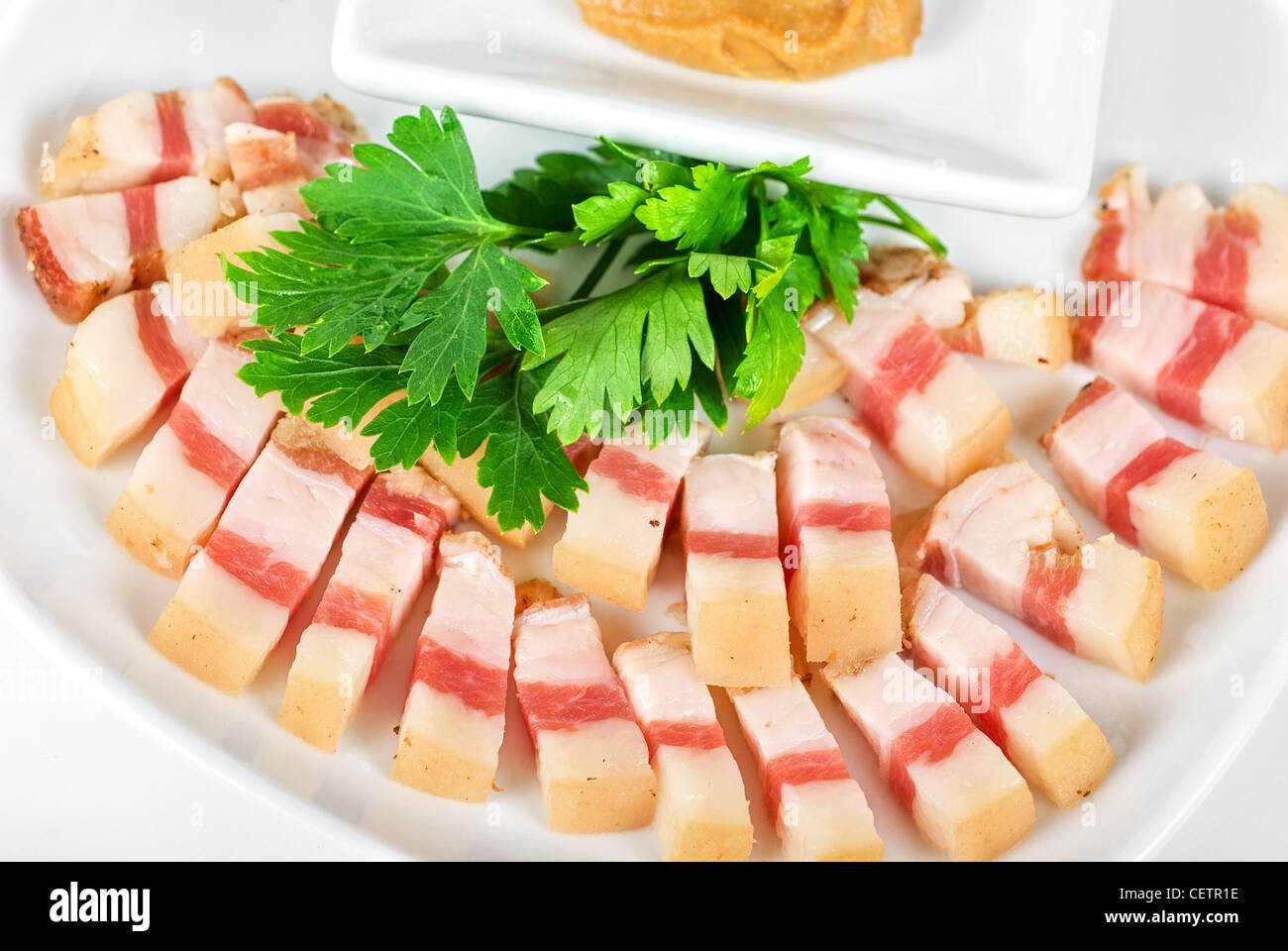 Sliced pig lard with greens closeup Stock Photo - Alamy