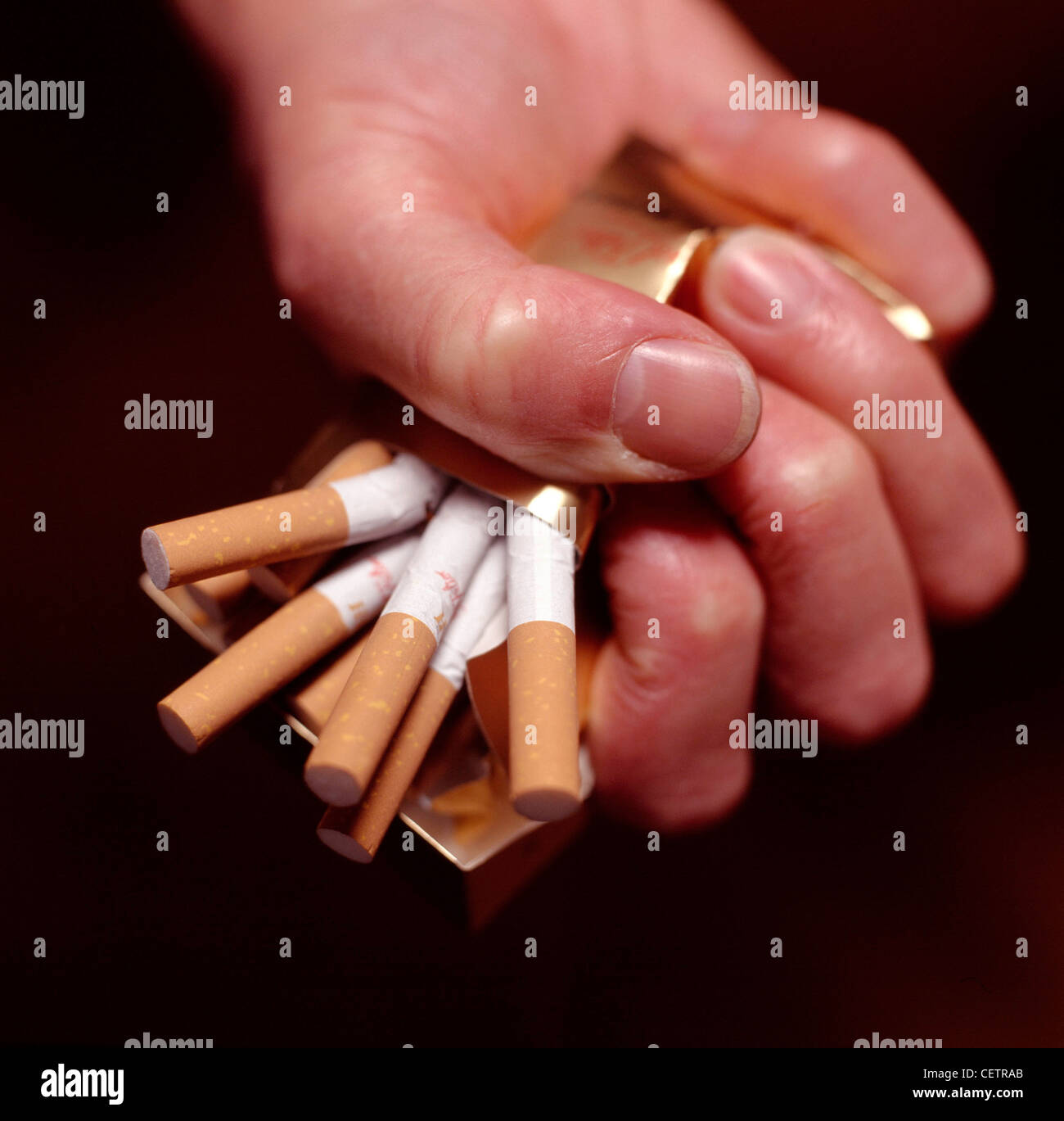 Close up of male hand crushing packet of unsmoked cigarettes Stock ...