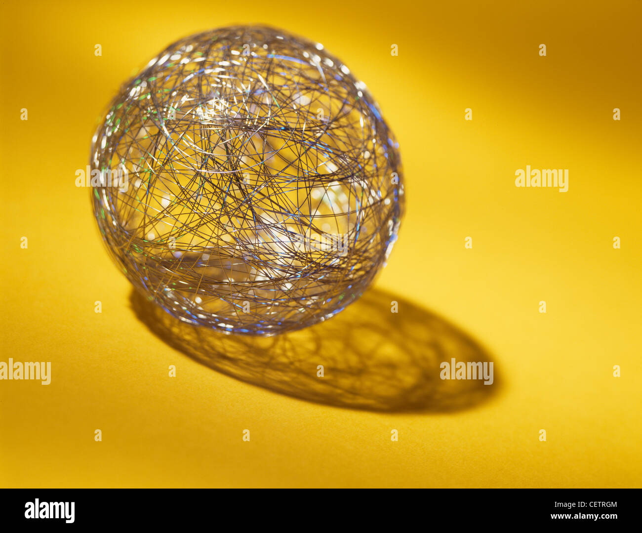 A round metal ball on a bright yellow background Stock Photo - Alamy