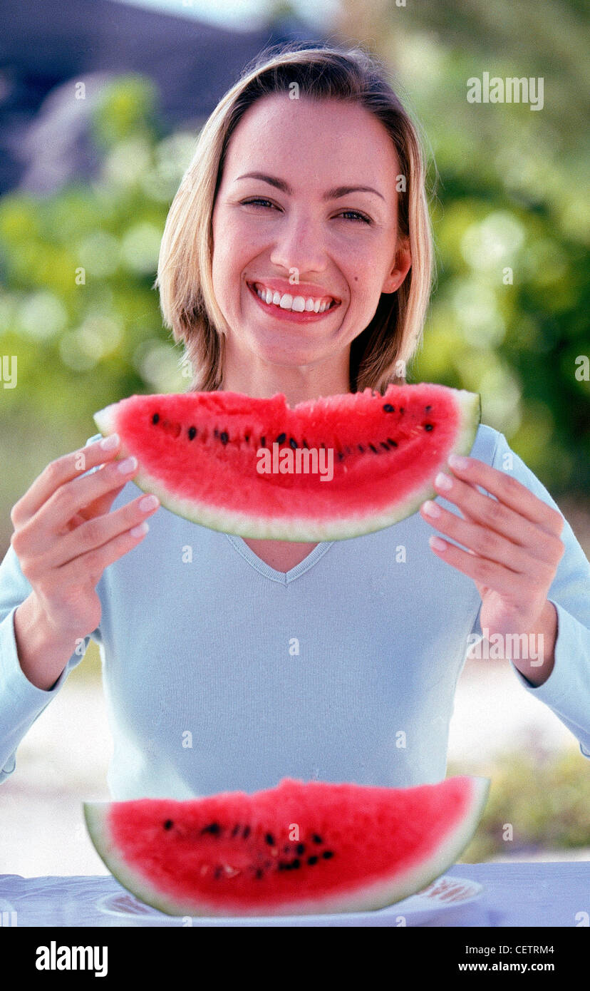 Female Shoulder Length Blonde Hair Wearing Blue Top Sitting At Table