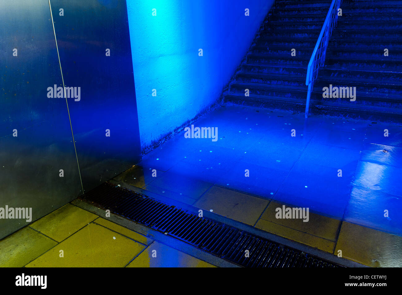 Underpass at night lit by blue neon in the rain Stock Photo - Alamy