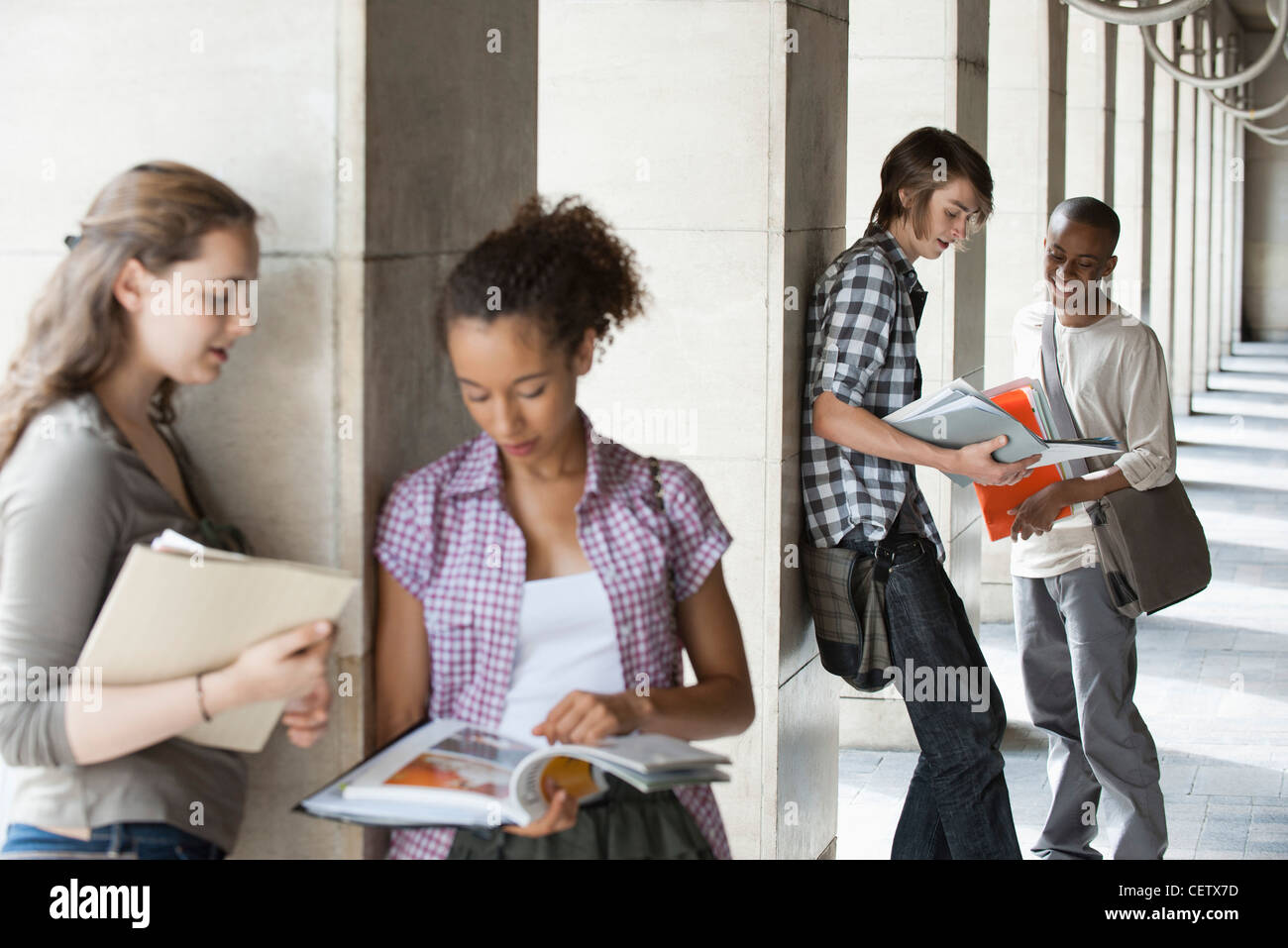 University students discussing homework, focus on men in background ...