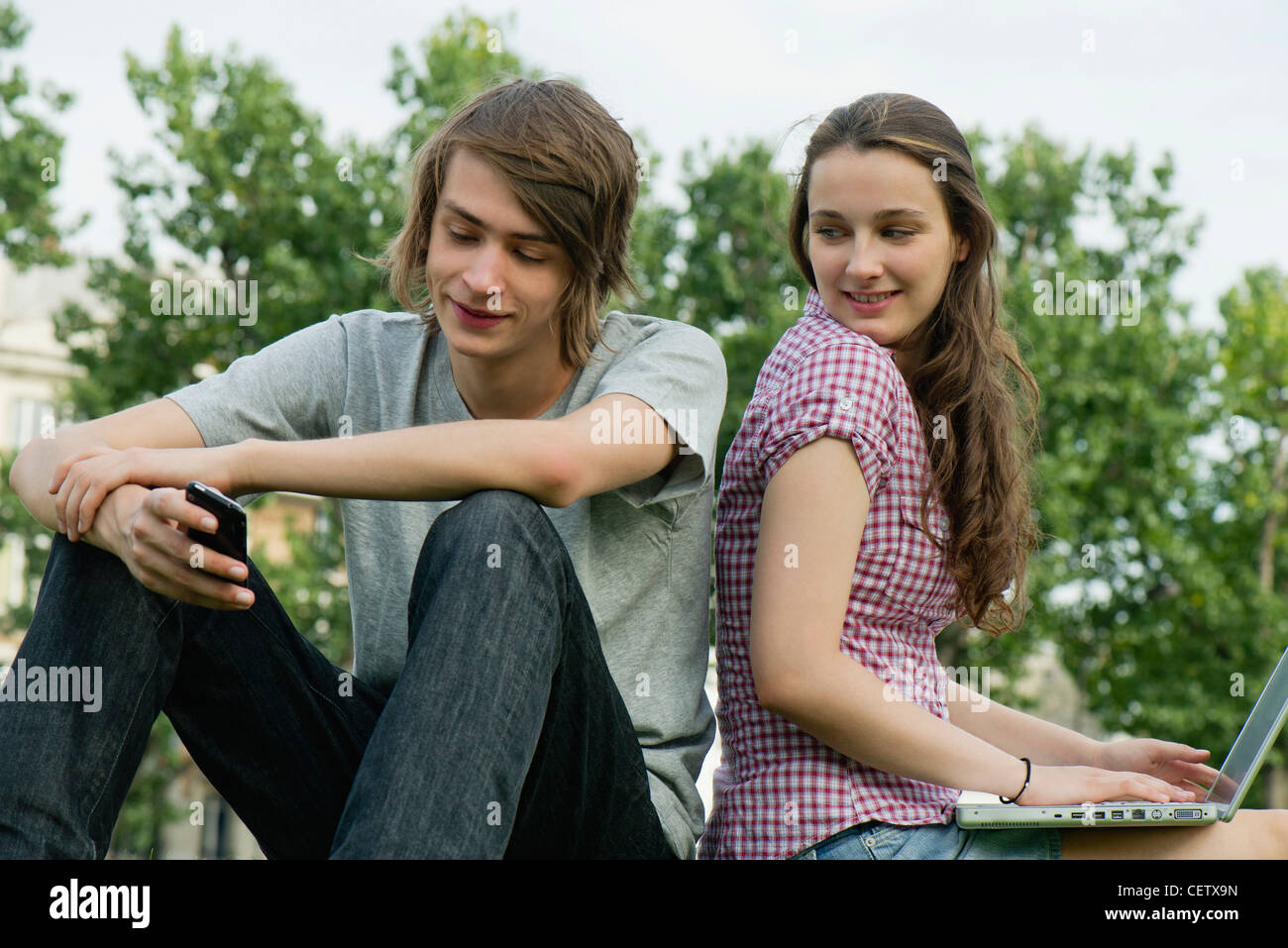 Couple using modern technologies outside hi-res stock photography and ...