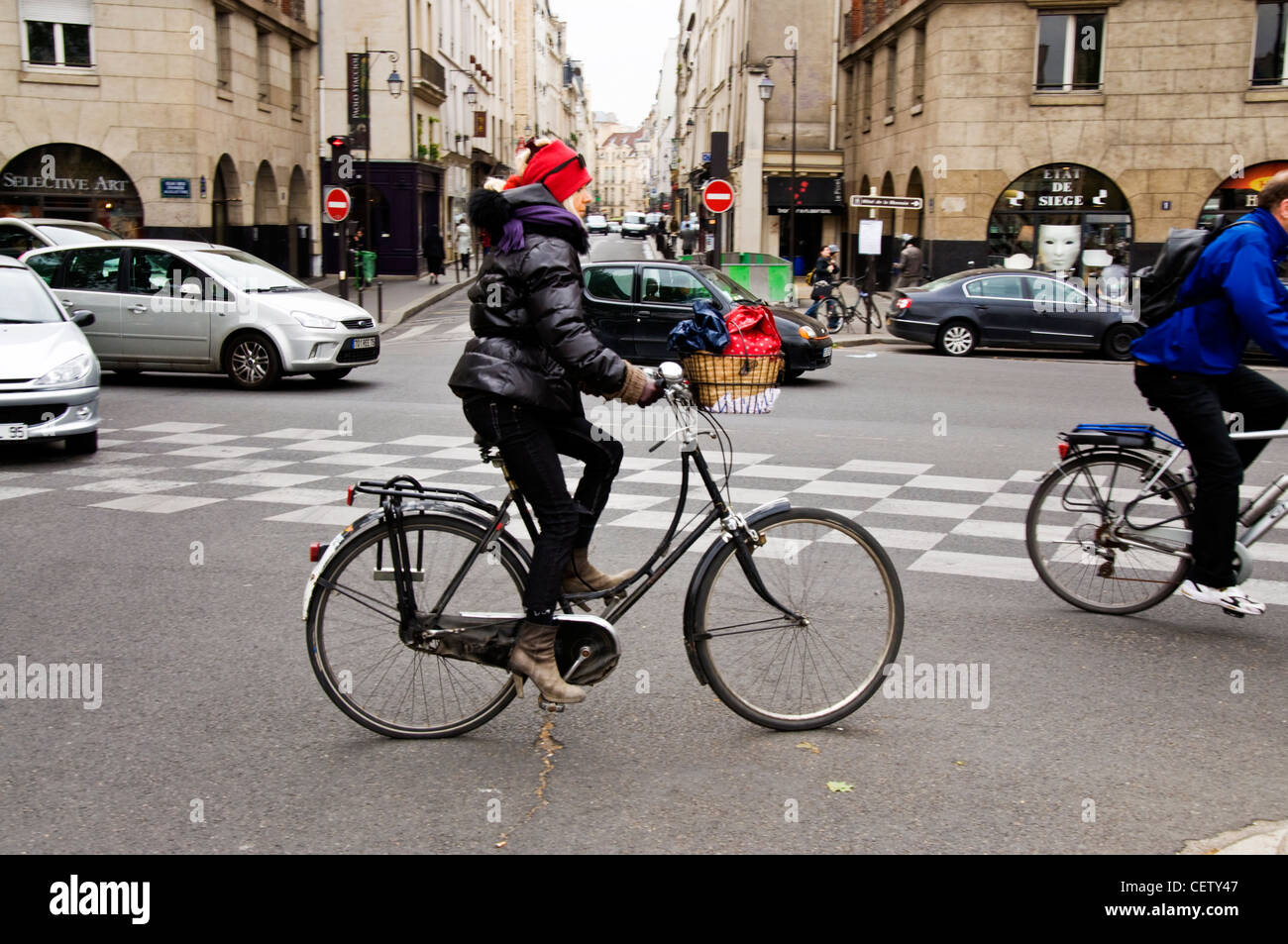 Woman cycling in Parisian street Stock Photo - Alamy