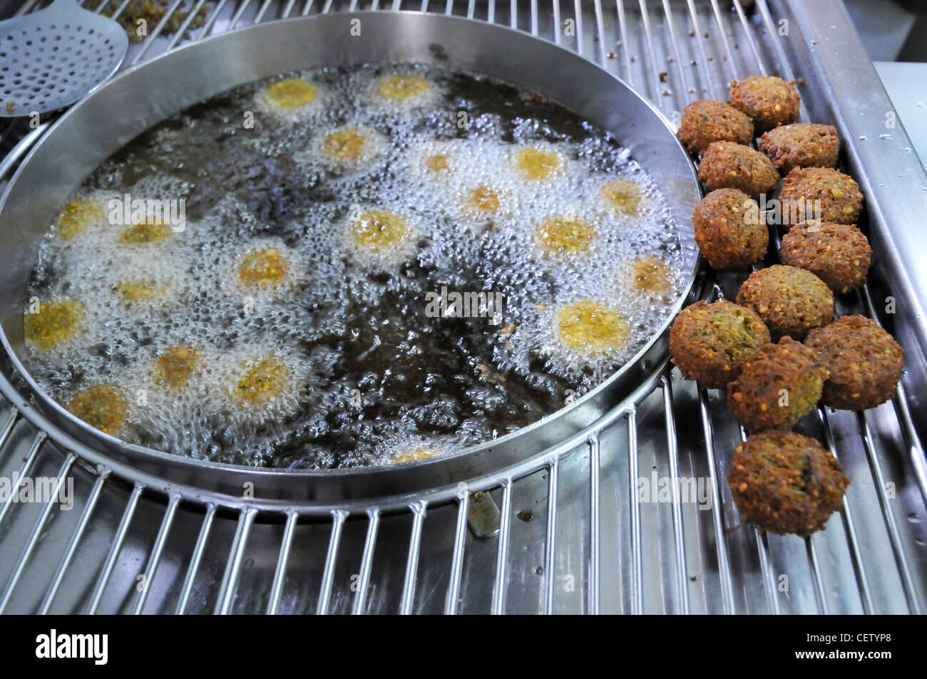 Deep frying Falafel (Small croquette of mashed chickpeas Stock Photo ...