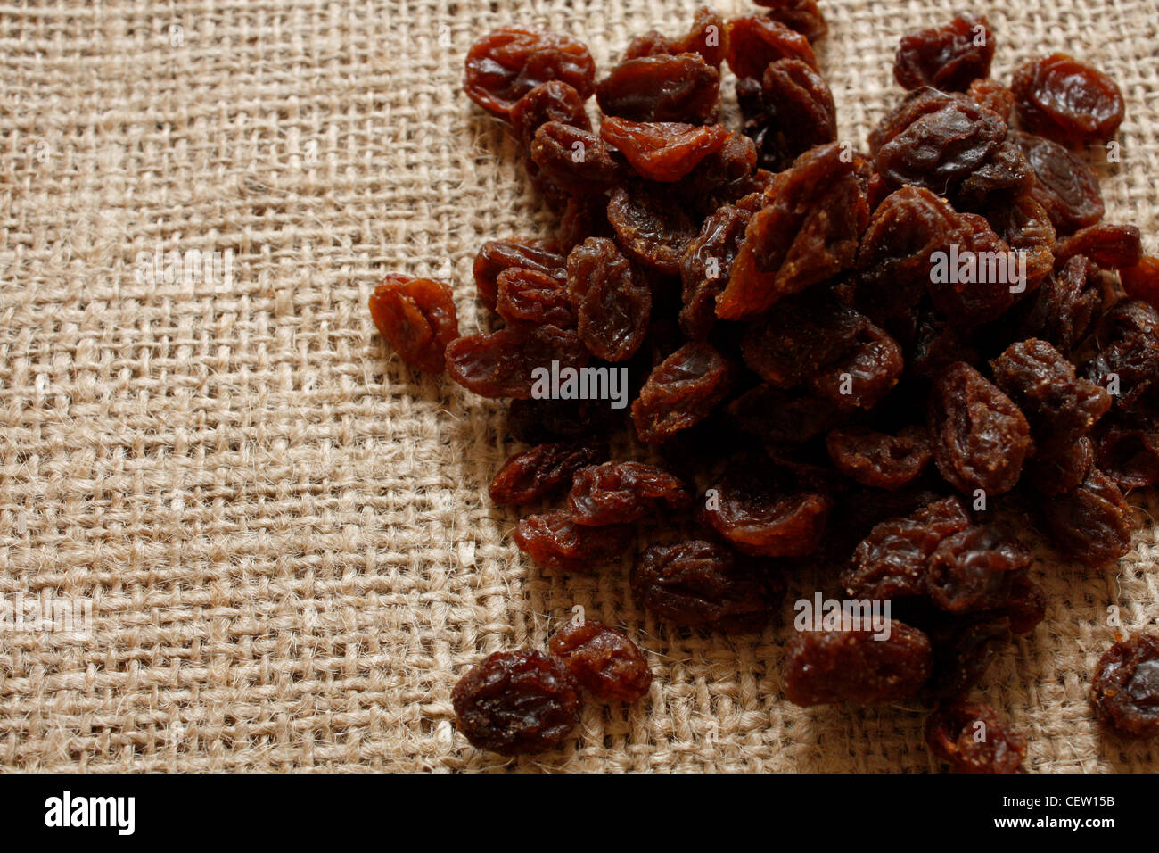 Raisins on a textured background Stock Photo - Alamy