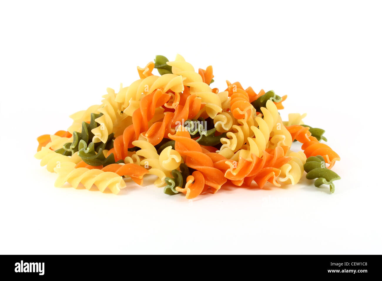 Raw colored pasta fusilli isolated on white background Stock Photo - Alamy