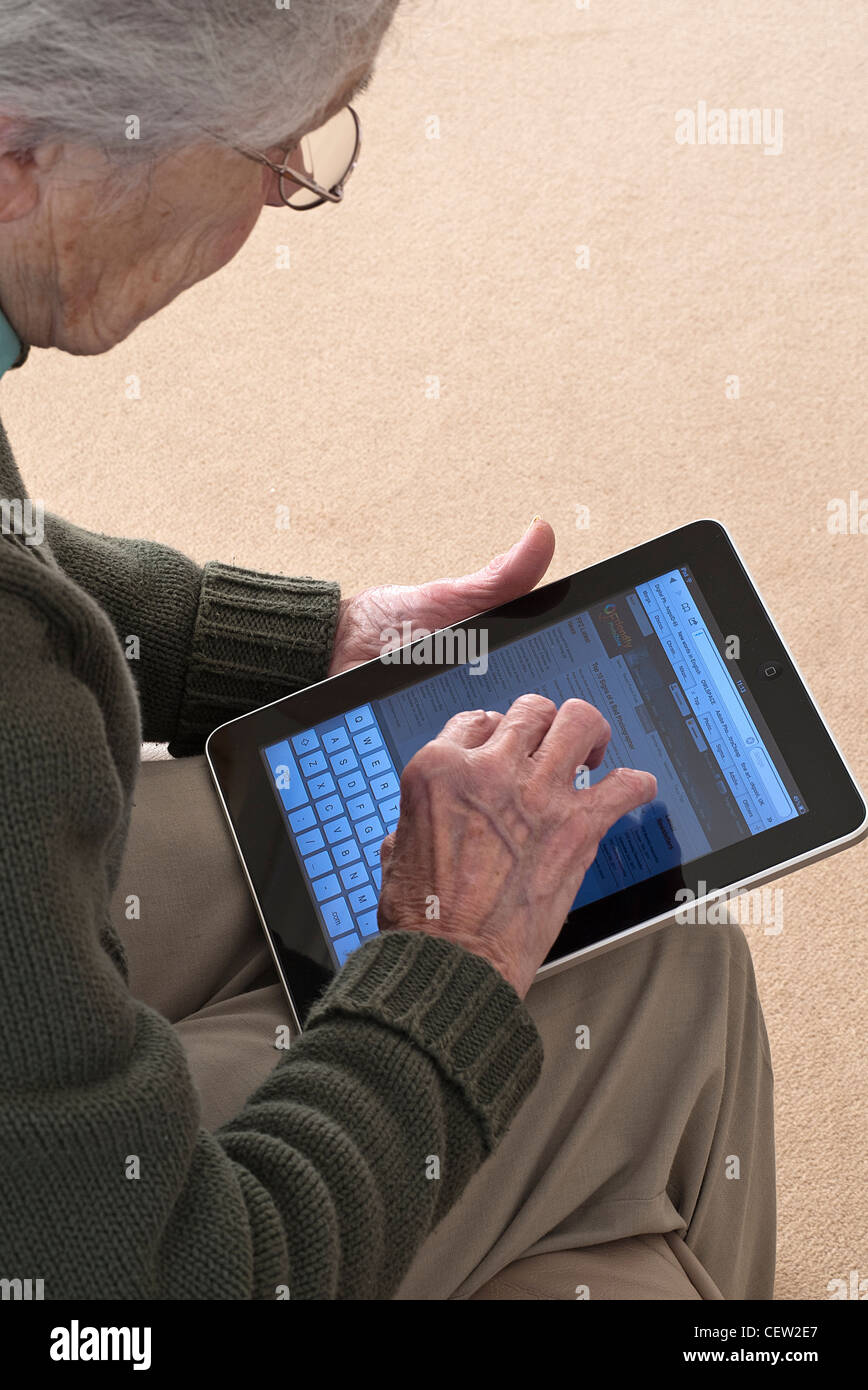 Mature Lady using an iPad Stock Photo - Alamy