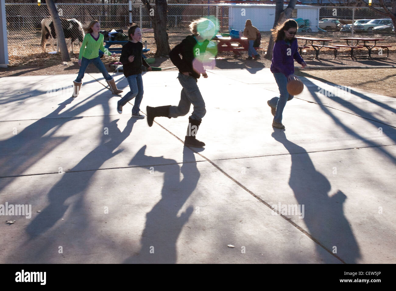 Shadows of children playing basketball outdoors at dusk Stock Photo - Alamy