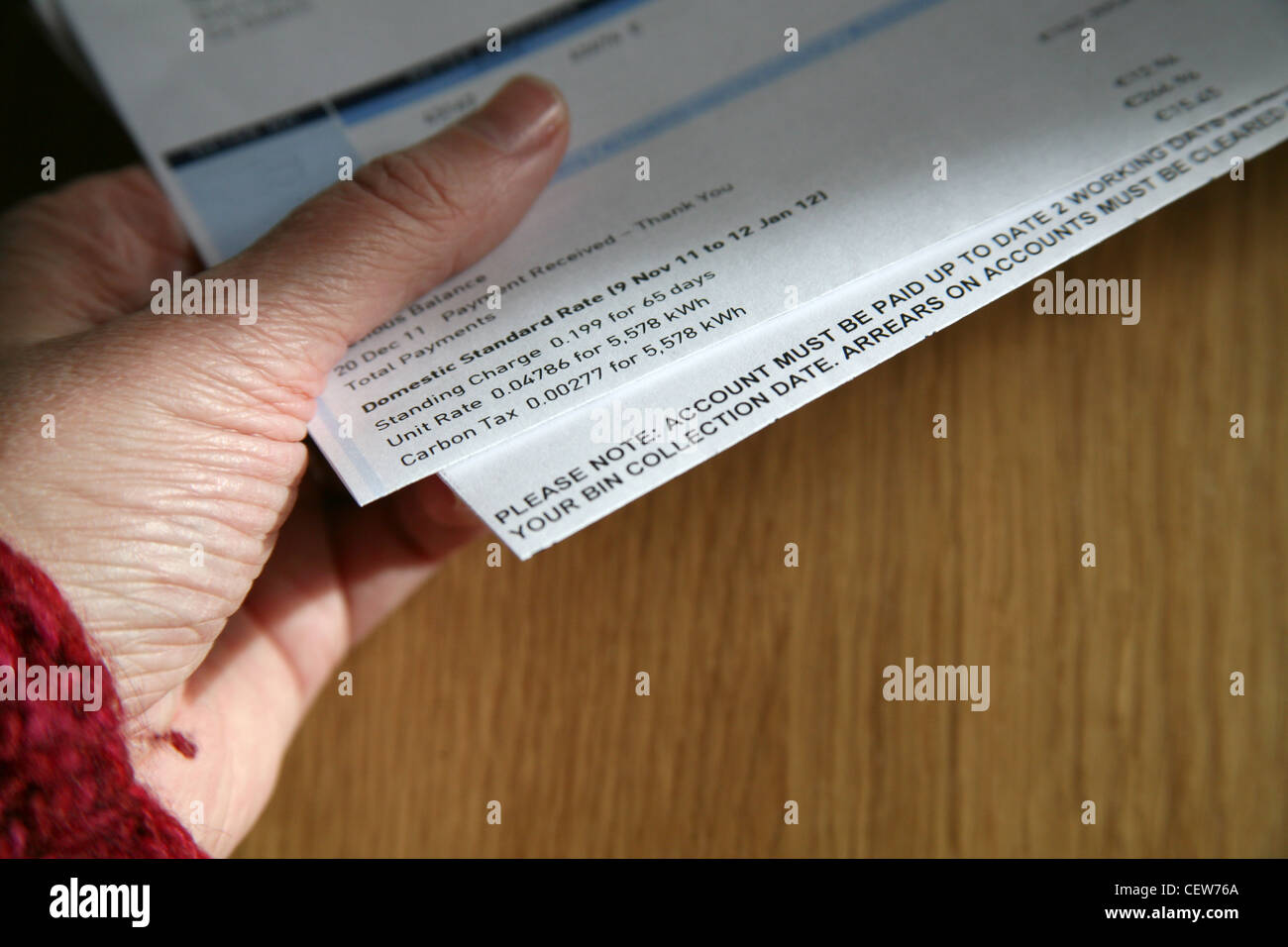 Hand holding household bills Stock Photo - Alamy