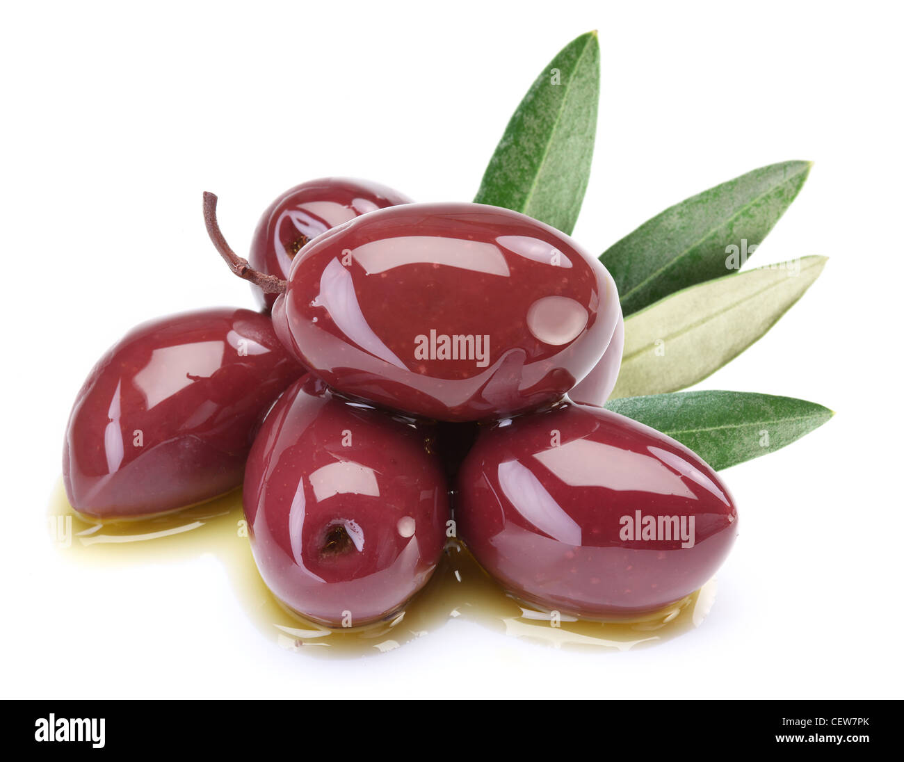 Purple olives in oil with leaves on a white background Stock Photo - Alamy