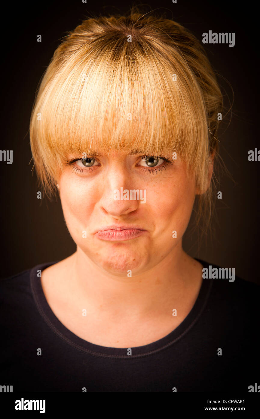 a blonde haired girl woman pulling a frowning face pout pouting moody ...