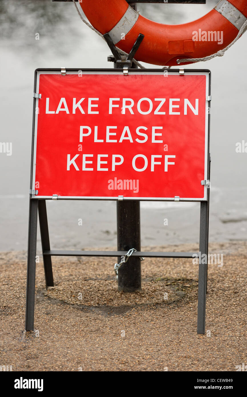 Bright red "Lake Frozen Please Keep Off" warning sign Stock Photo - Alamy