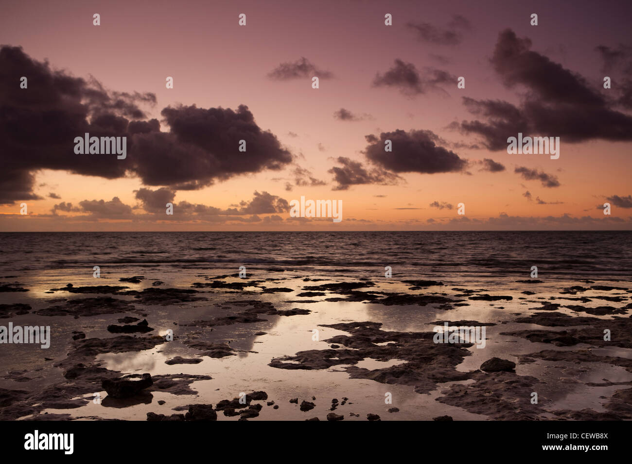 Dawn sunlight and rocky coast at Spanish Key, Florida, USA Stock Photo ...