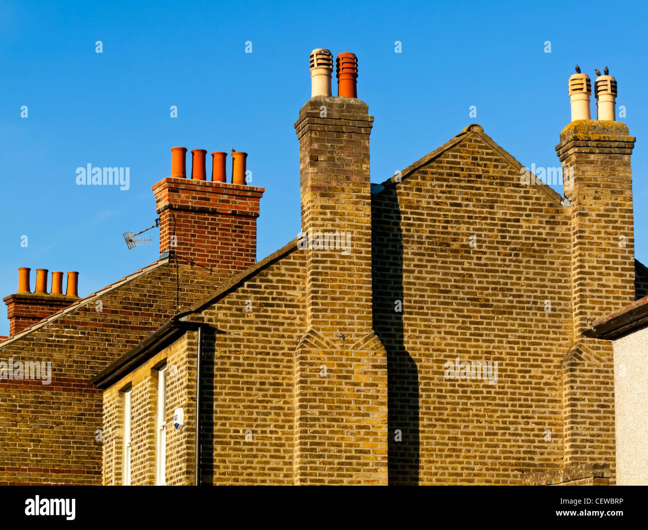 Chimneys on a traditional Victorian brick house in England with blue ...