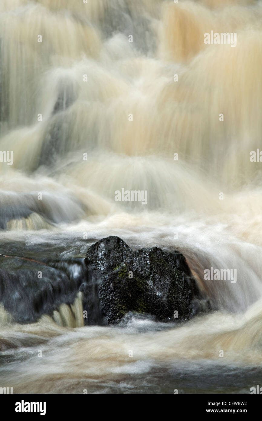 A close up image of water rushing over rocks in a waterfall Stock Photo ...