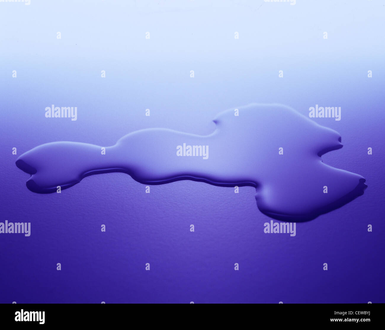 Puddles of water on a blue reflective surface Stock Photo - Alamy