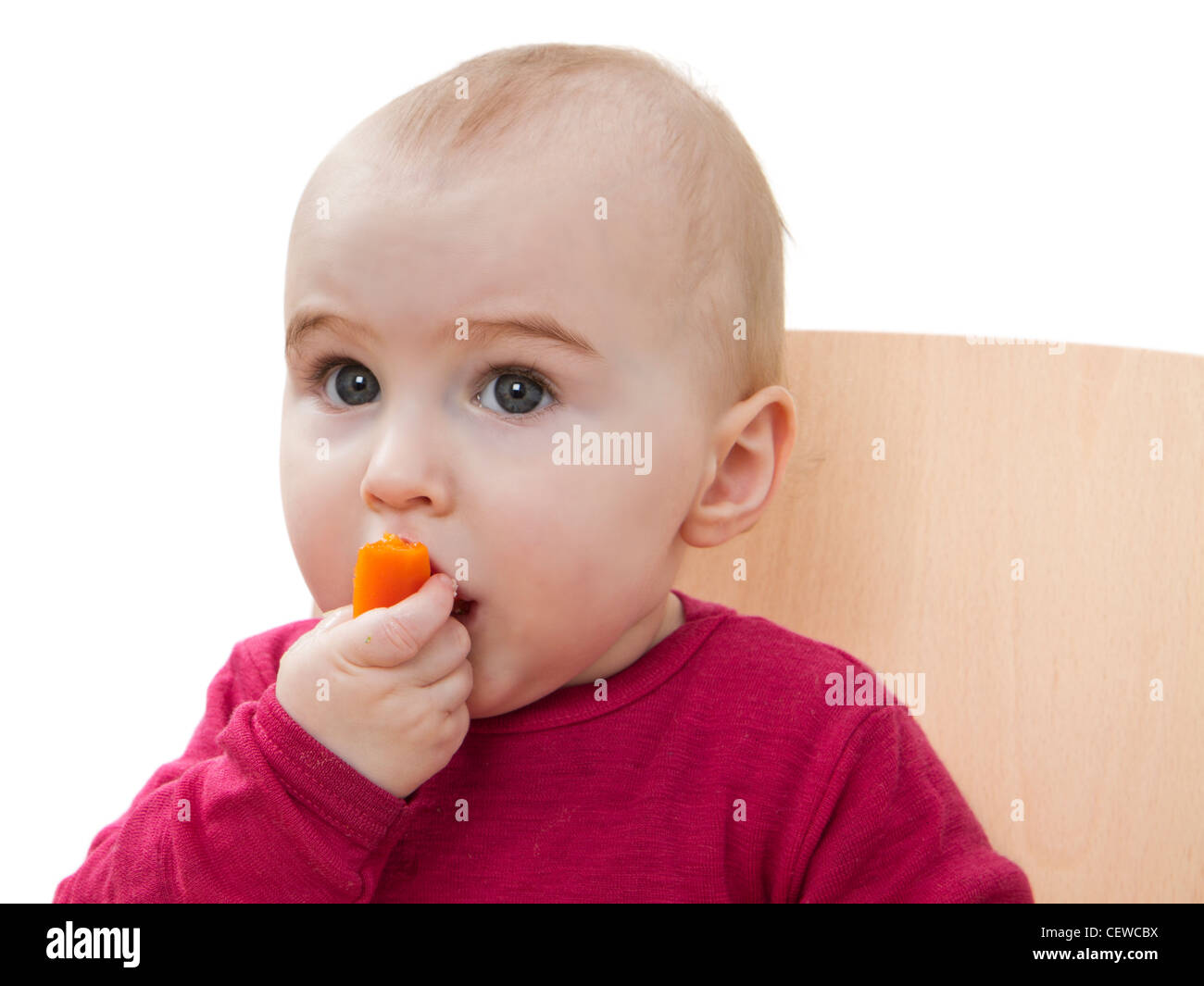 child in red shirt eating. white background Stock Photo - Alamy