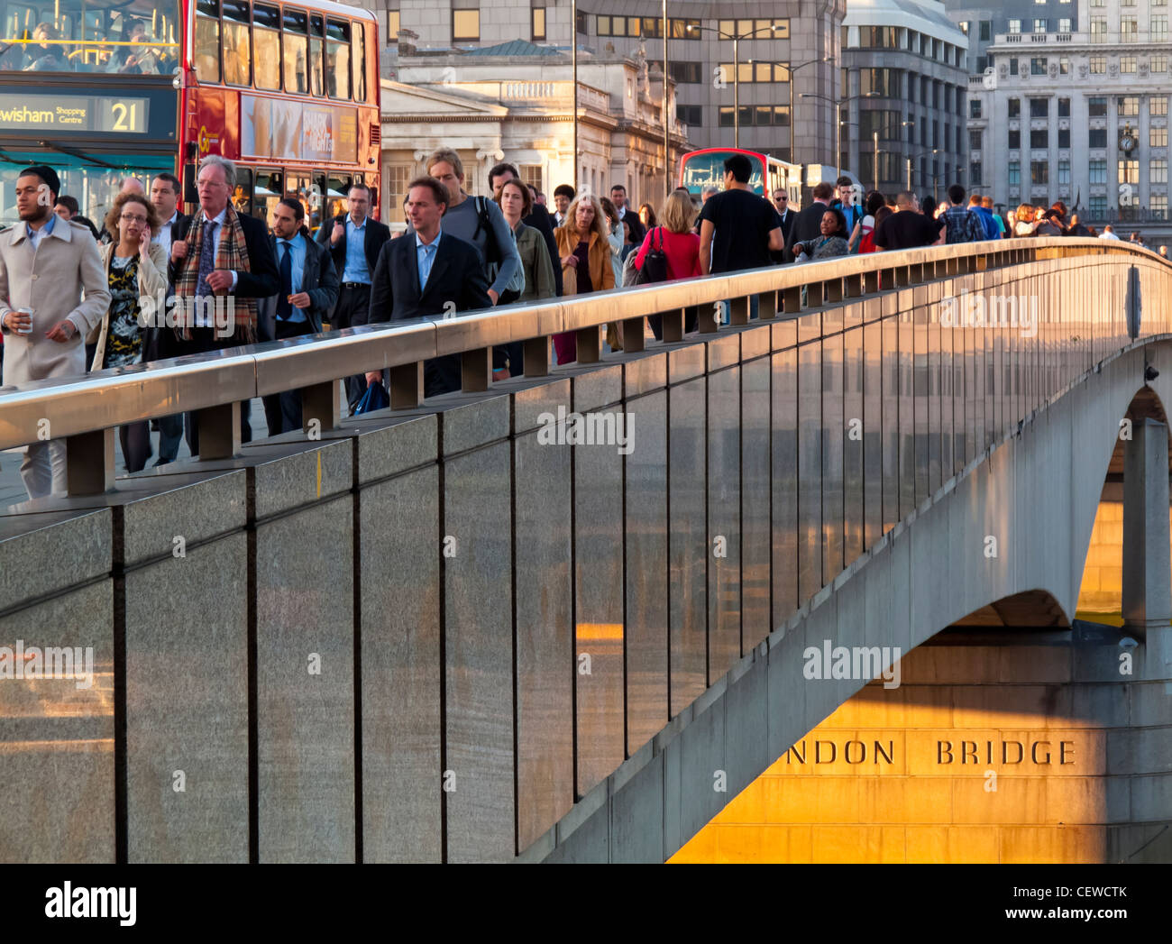 Rush hour commuters crossing London Bridge over the River Thames in the ...
