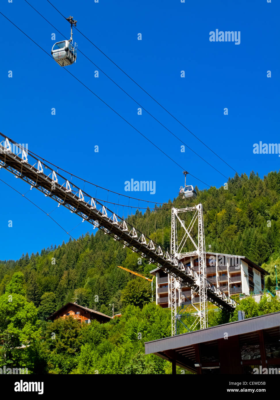 Suspension bridge and cable car over a valley in Morzine in the Haute ...