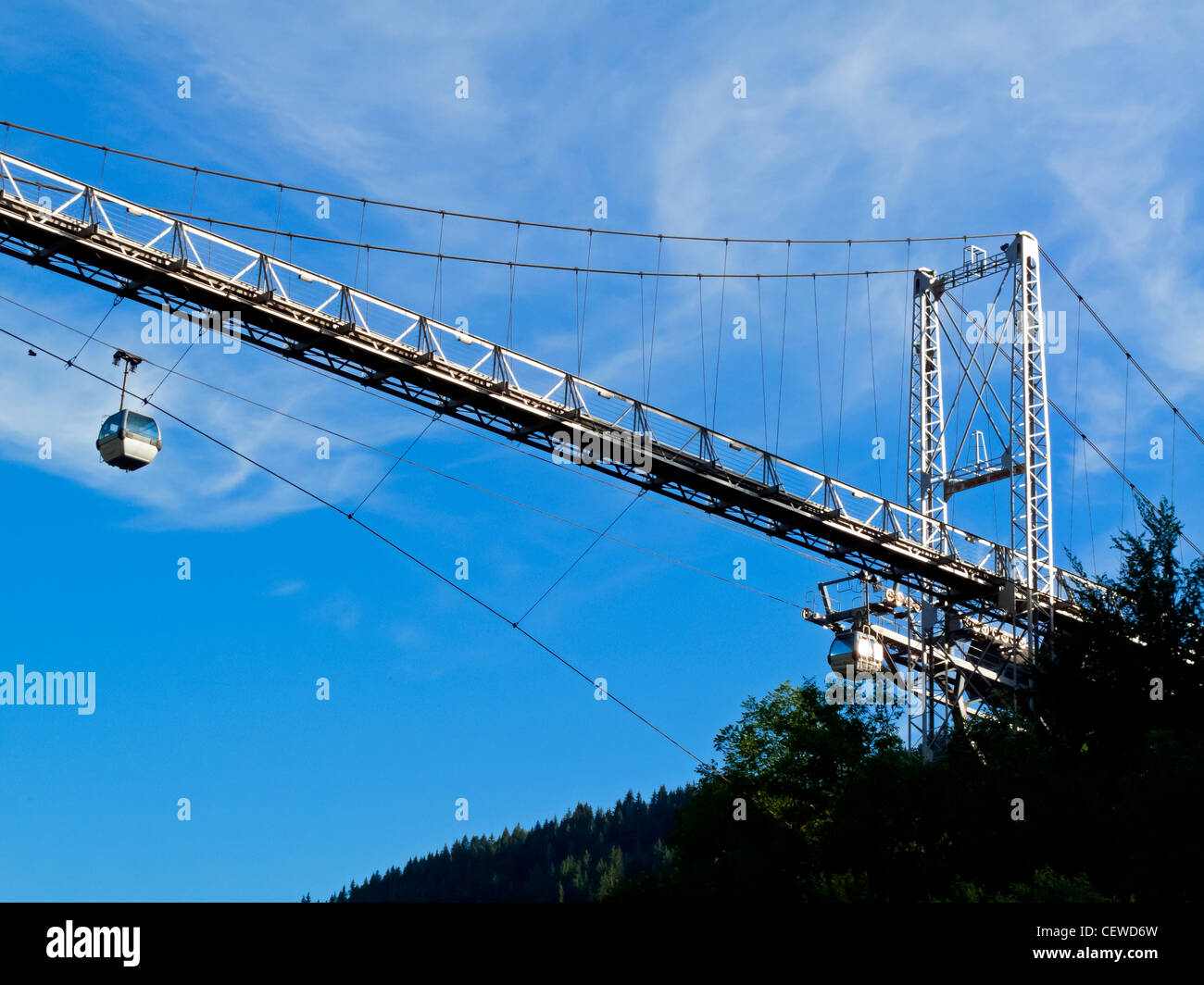Suspension bridge and cable car over a valley in Morzine in the Haute ...