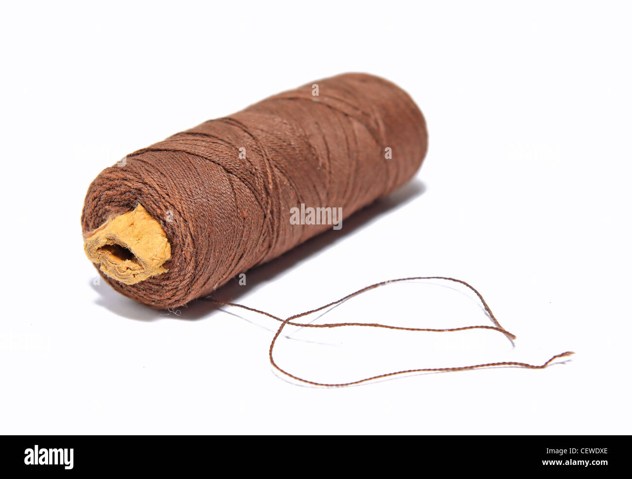 spool of the brown threads on white background Stock Photo - Alamy