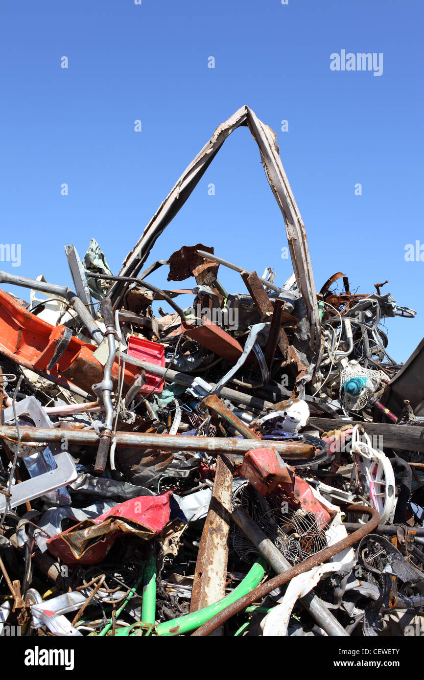 Stack of scrap metal against blue sky Stock Photo - Alamy