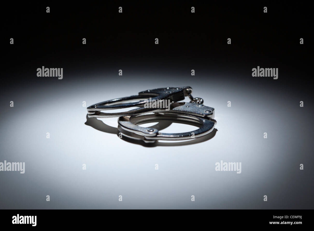 Abstract Pair of Handcuffs Under Spot Light on Gradated Background ...