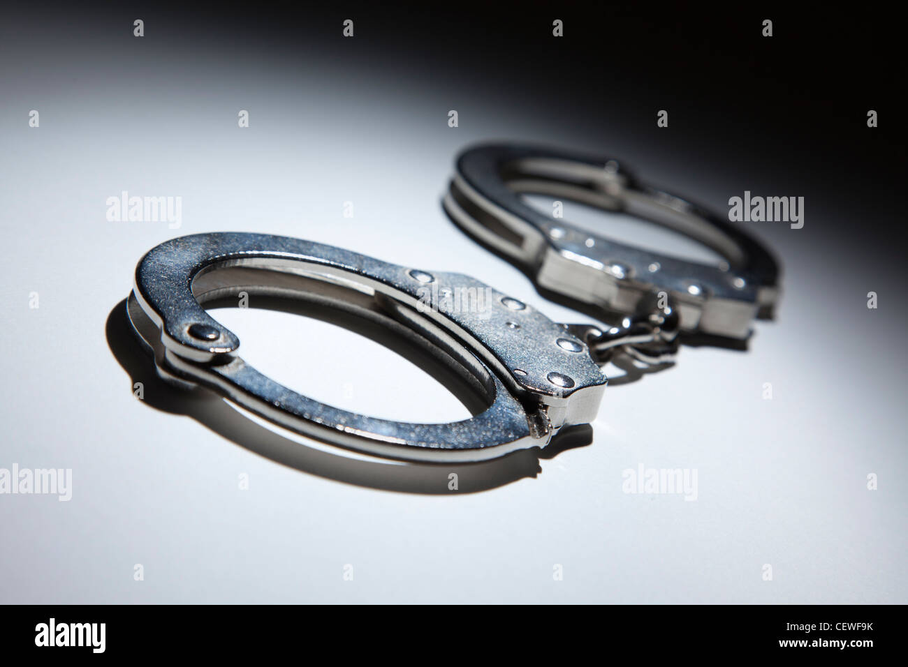Abstract Pair of Handcuffs Under Spot Light on Gradated Background ...