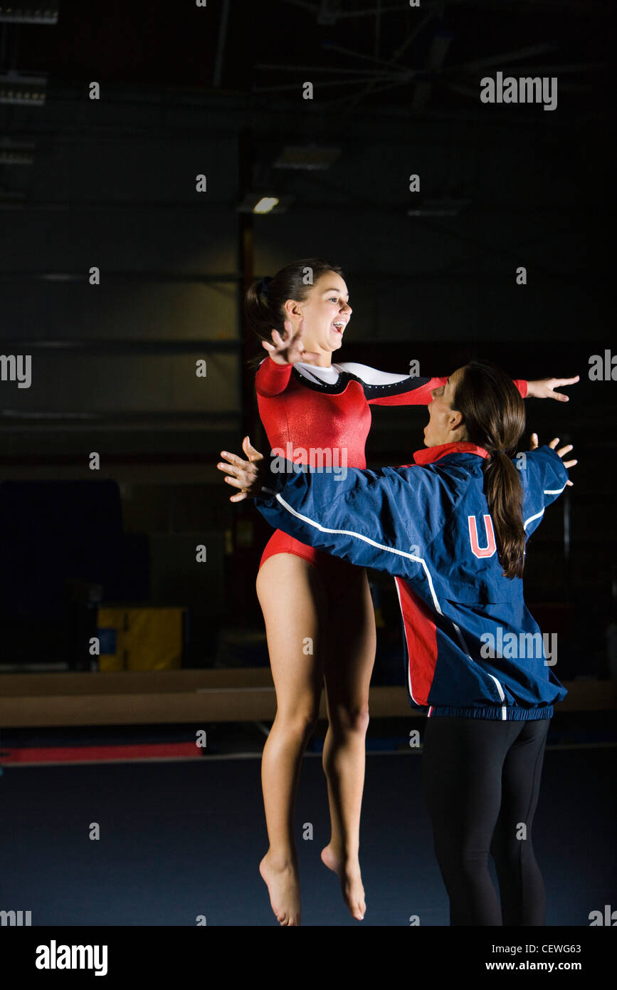 Female gymnast training with coach Stock Photo - Alamy