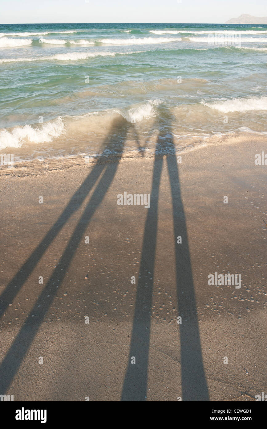Shadows of couple on beach Stock Photo - Alamy